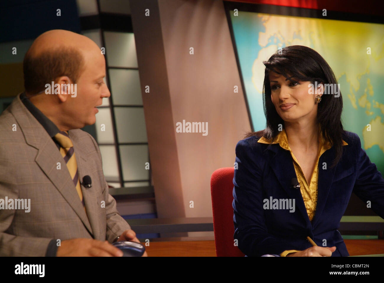 Al Jazeera satellite TV anchors Habib Ghribi and Lina Zahreddine read a ...