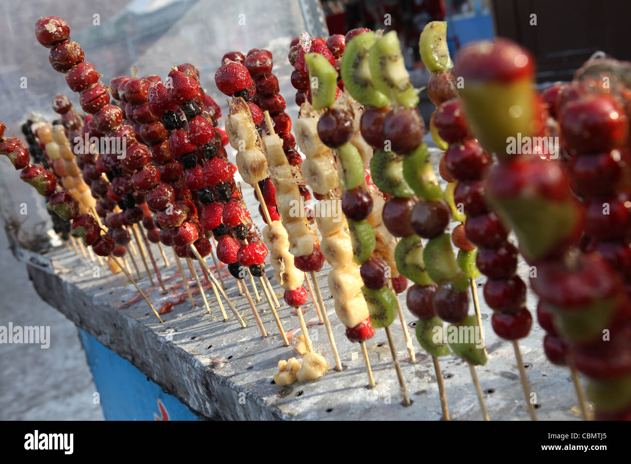 Frozen sweet fruits on a stick for sale, harbin, China, Heilongjiang ...