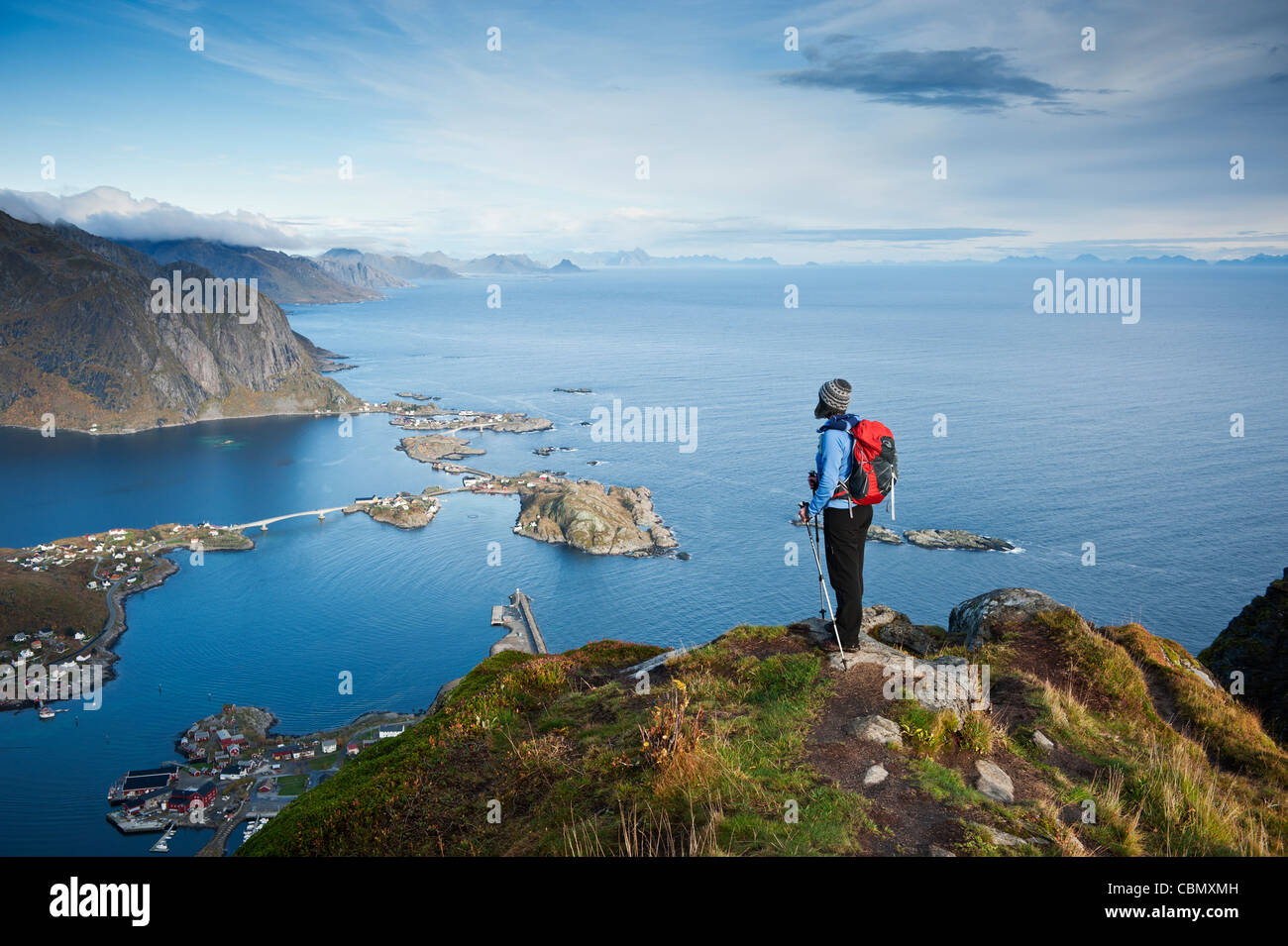 Female hiker enjoys spectacular view over mountains and fjords from ...
