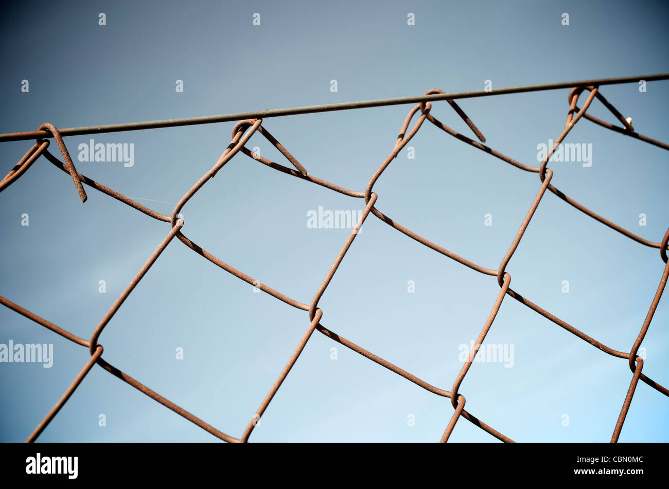 Close up of a rusty metal fence with a blue background Stock Photo - Alamy