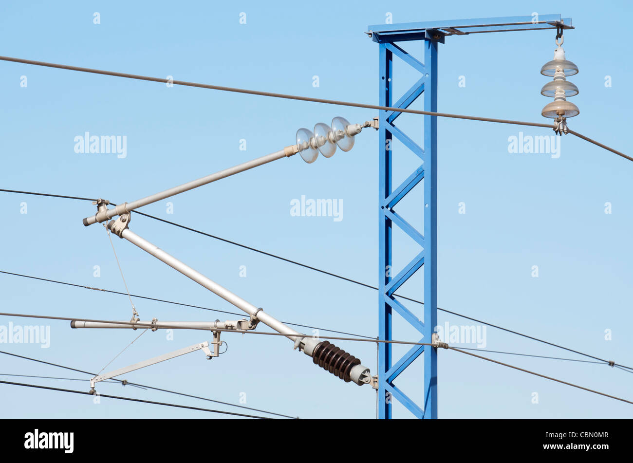 forefront of a railway catenary with a blue sky Stock Photo - Alamy