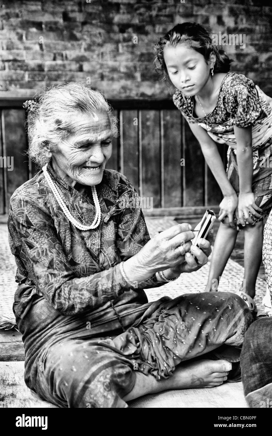 Great image of modern technology with old woman and new PDA computer in ...