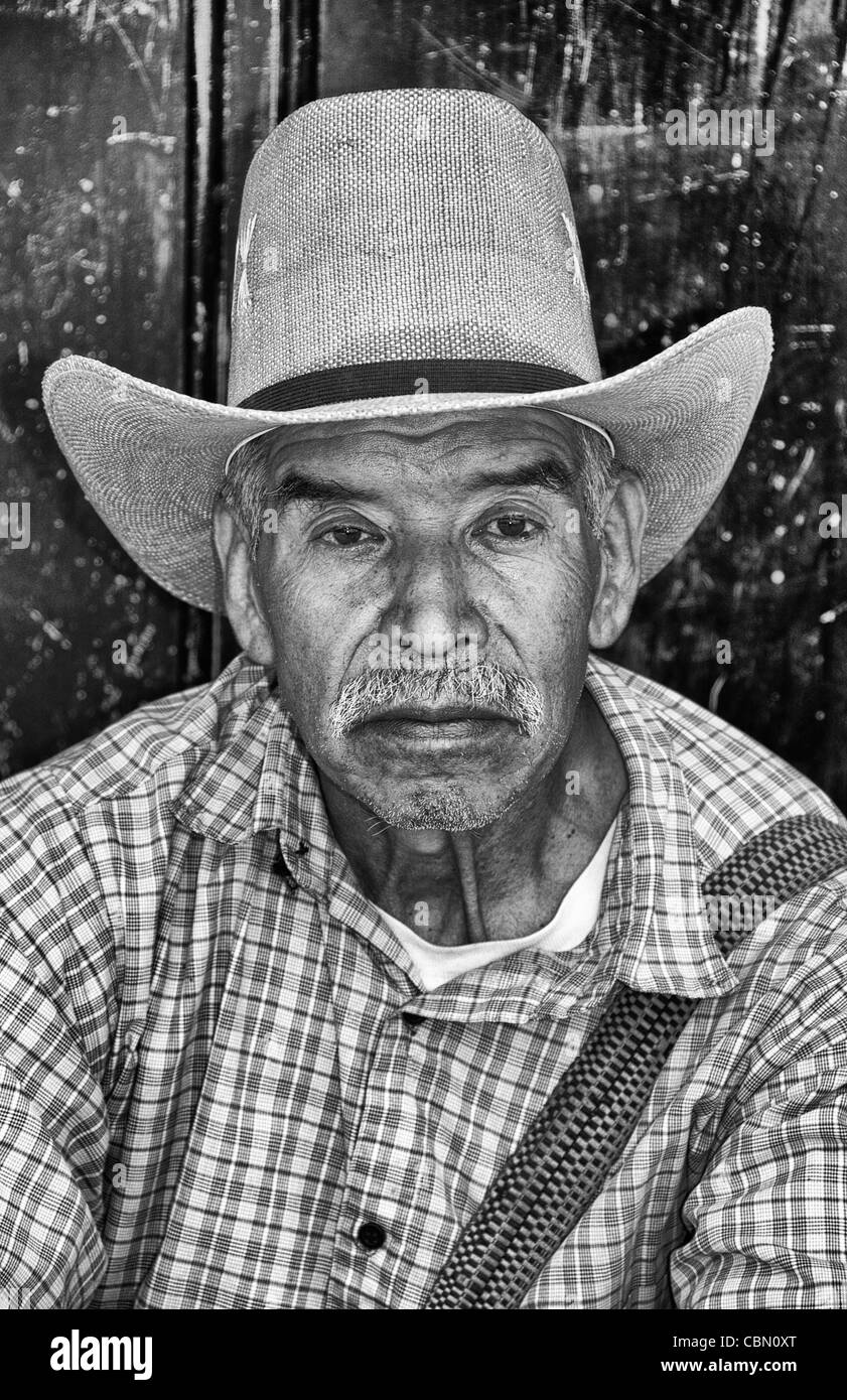 Poor man portrait in cowboy hat portrait in Lake Atitlan village of San ...
