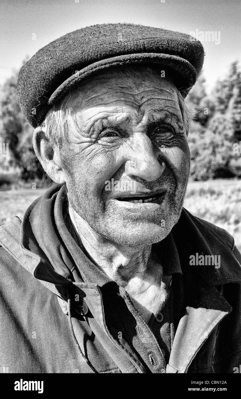 Portrait of poor farming man with his cow in rural farms between Kiev ...