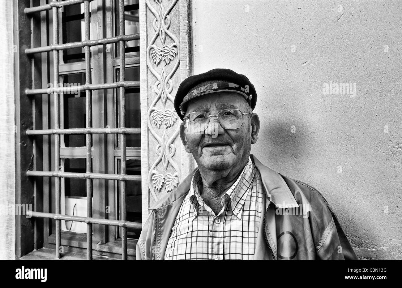Local man in Greek hat in downtown Mykonos Greece in Greek Islands of ...