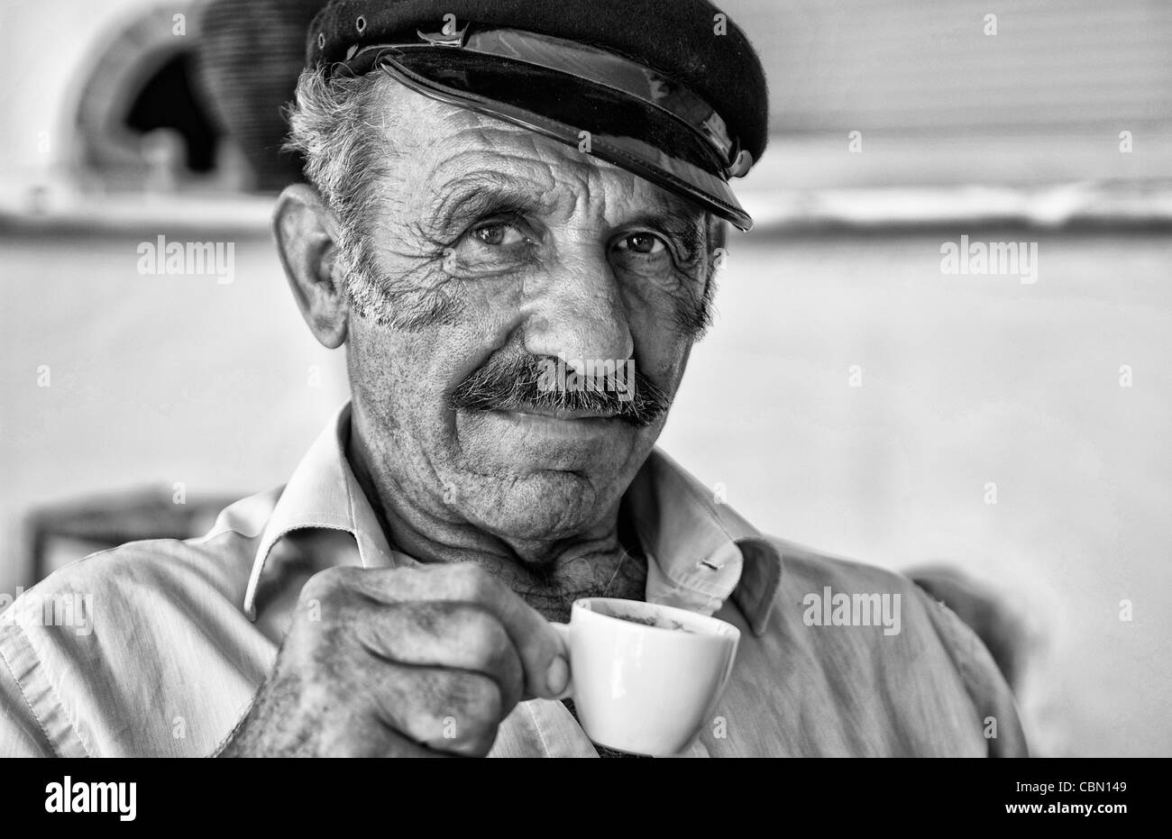 Local man portrait with Greek coffee with Greek hat at restuarant in ...
