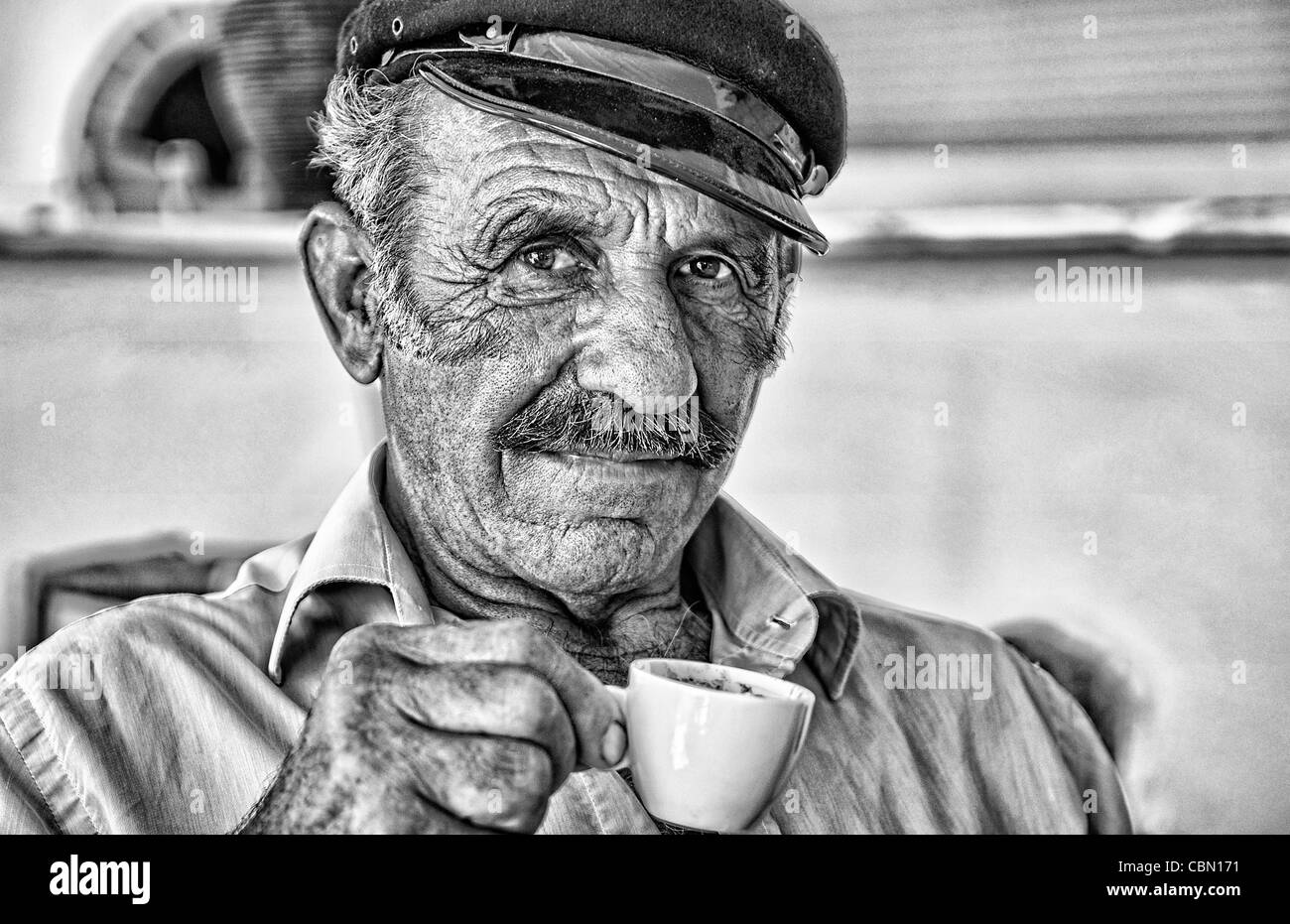 Local man portrait with Greek coffee with Greek hat at restuarant in ...