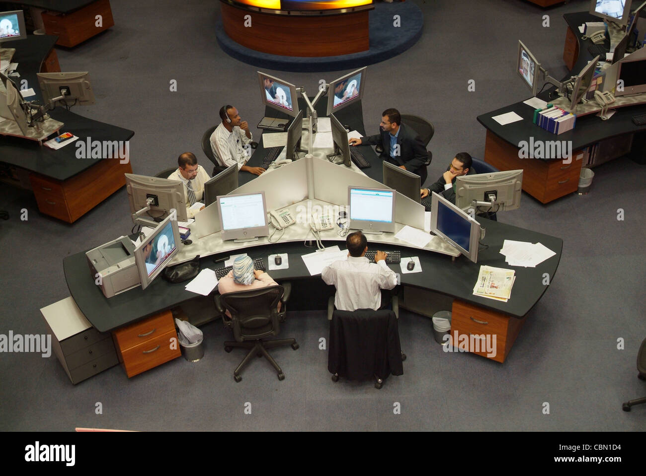 Al Jazeera Television newsroom with reporters and editors researching ...