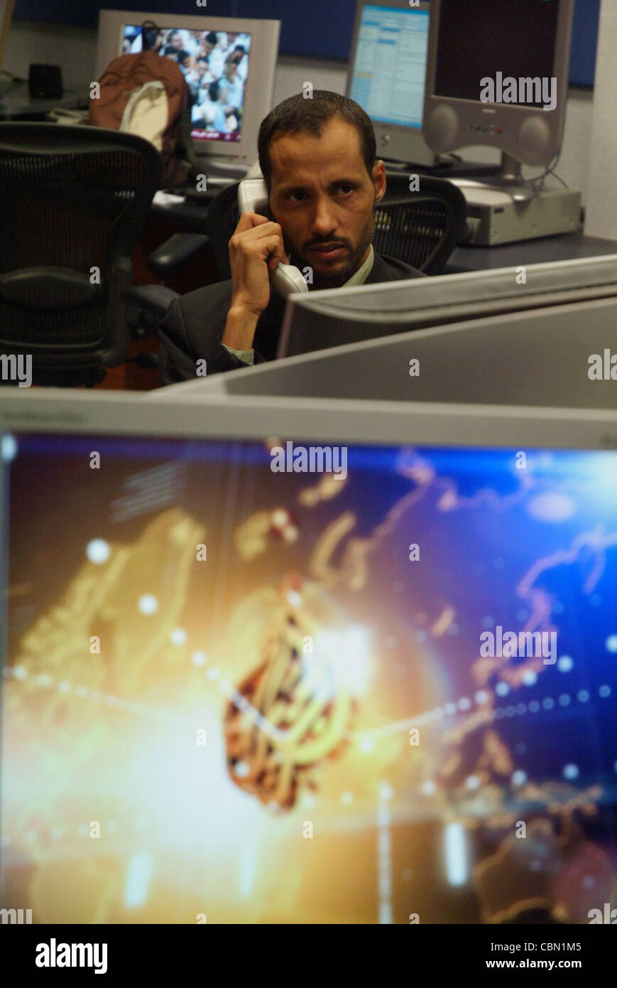 Al Jazeera Television newsroom with reporters and editors researching ...