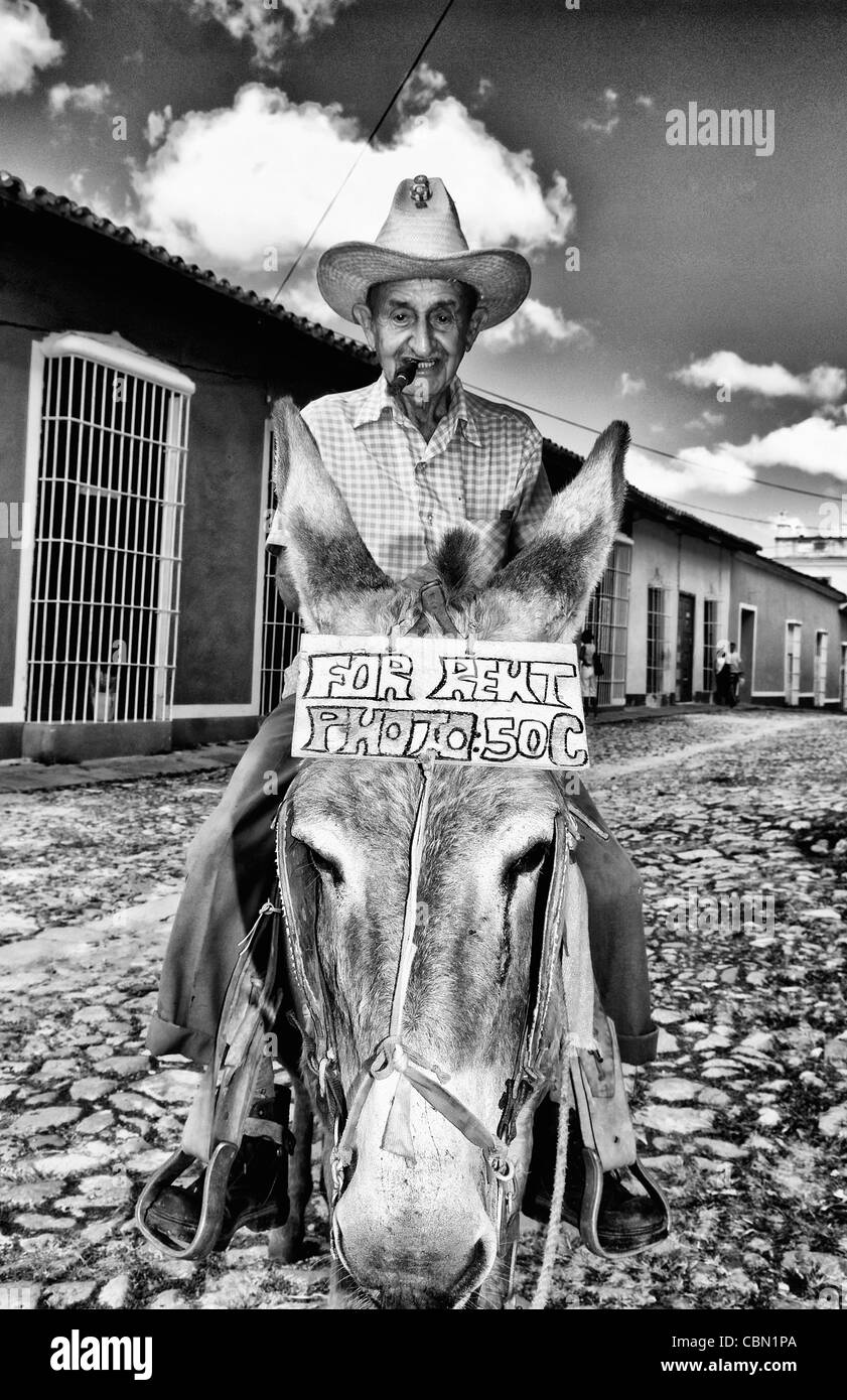 Old man with his donkey for rides on streets of old village of Trinidad ...