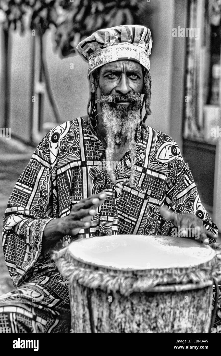 Colorful Rasta Jamaican Reggae performer on drum in costume at Harbour ...