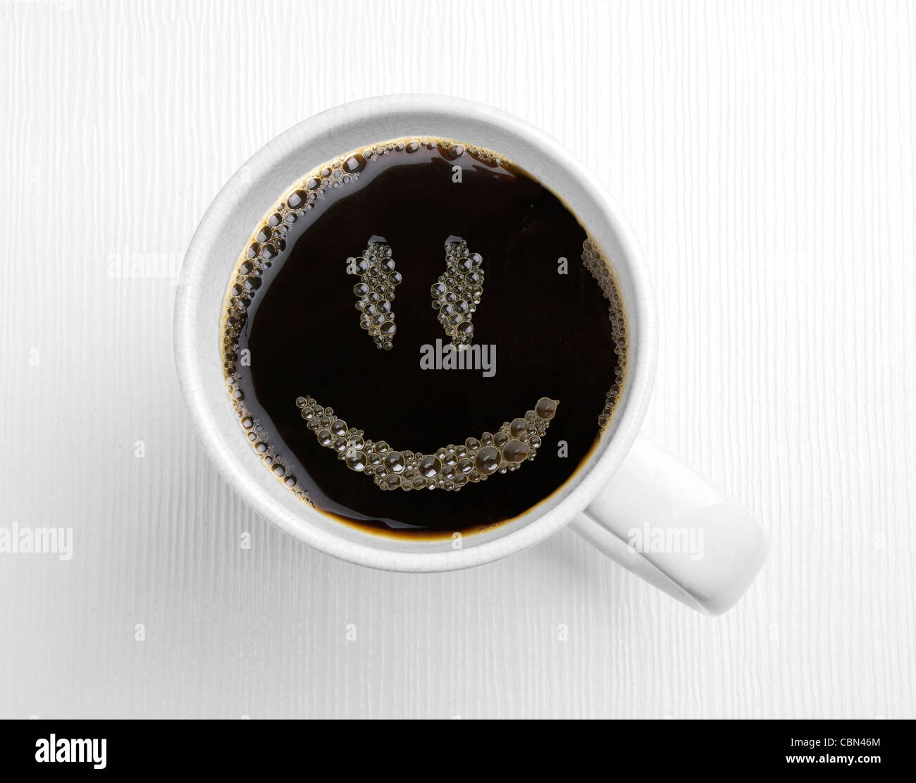 Black coffee with smiley face on white Stock Photo - Alamy