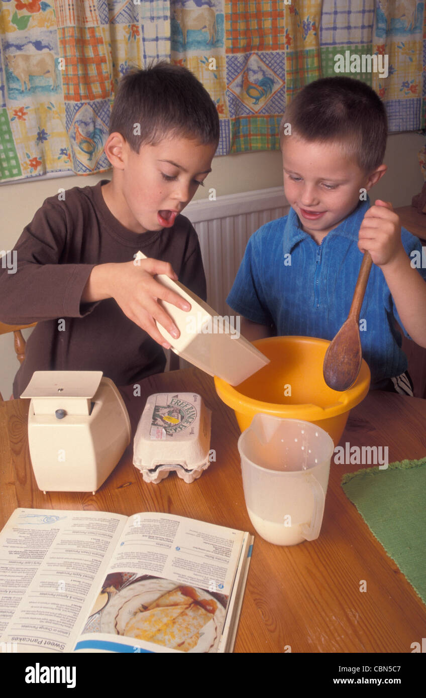two young boys making pancakes Stock Photo - Alamy