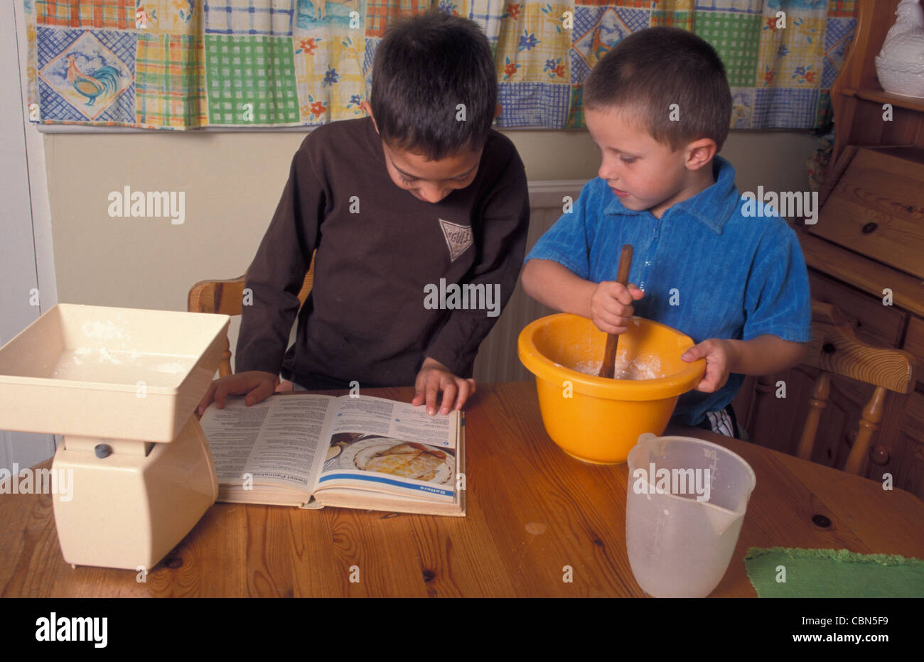 two young boys making pancakes Stock Photo - Alamy