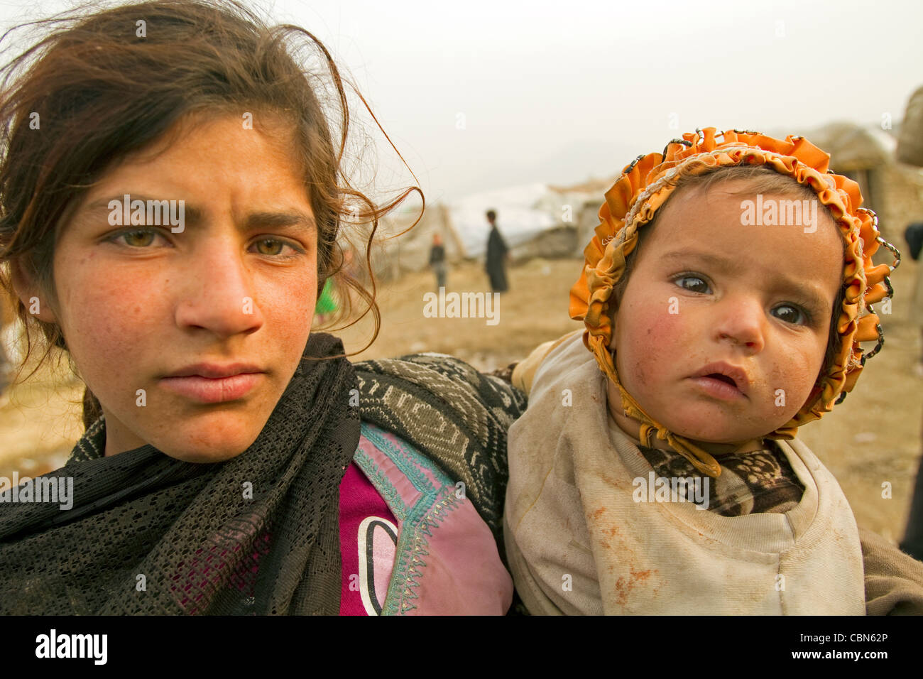 Portrait of young Afghan mother and baby living in poor conditions ...