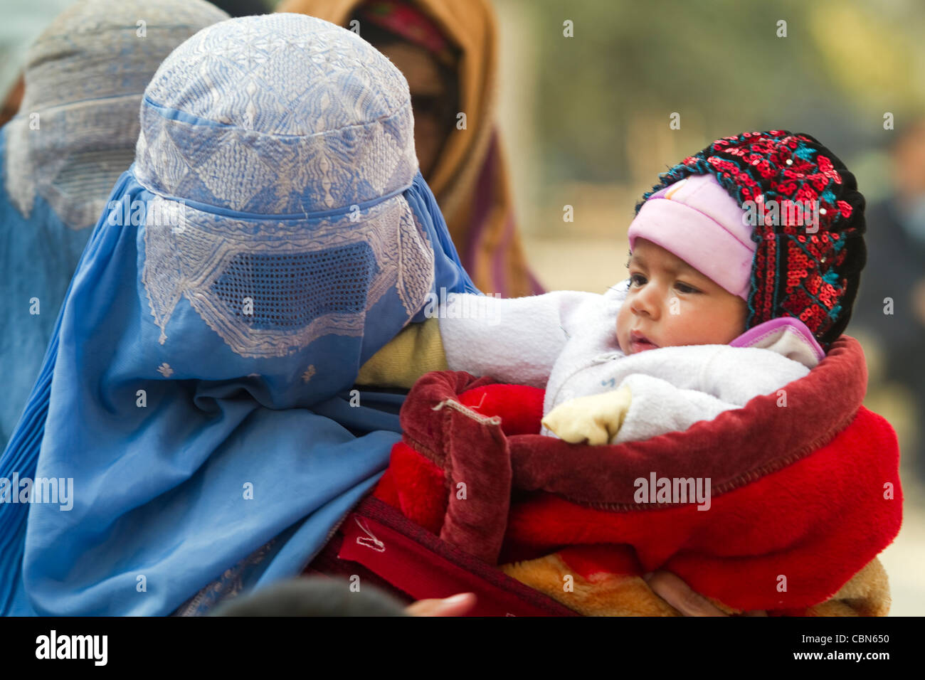 Afghan woman in burka waiting for aid with her baby Kabul Afghanistan ...