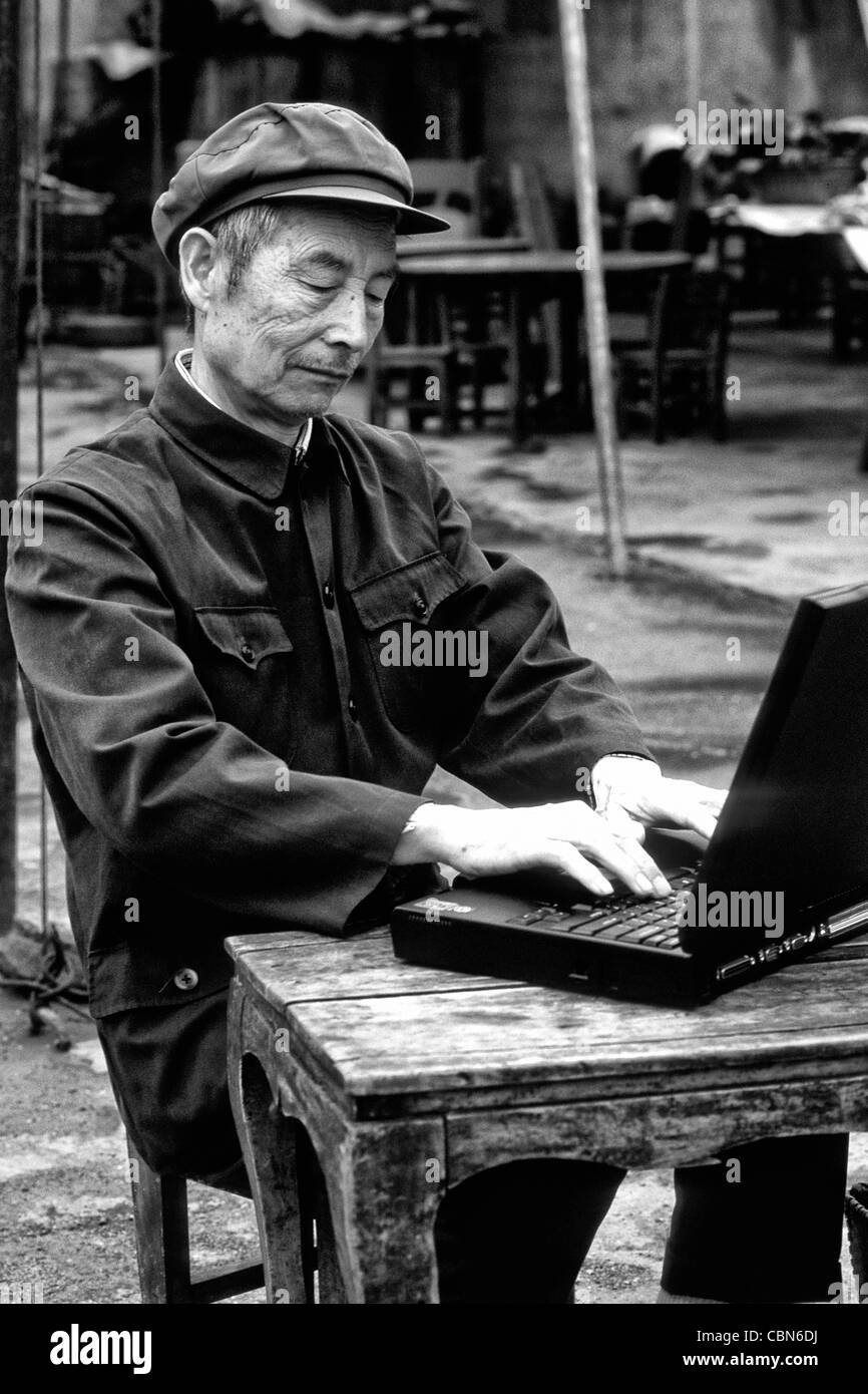 Old Chinese man on laptop computer in Shanghai China Stock Photo - Alamy