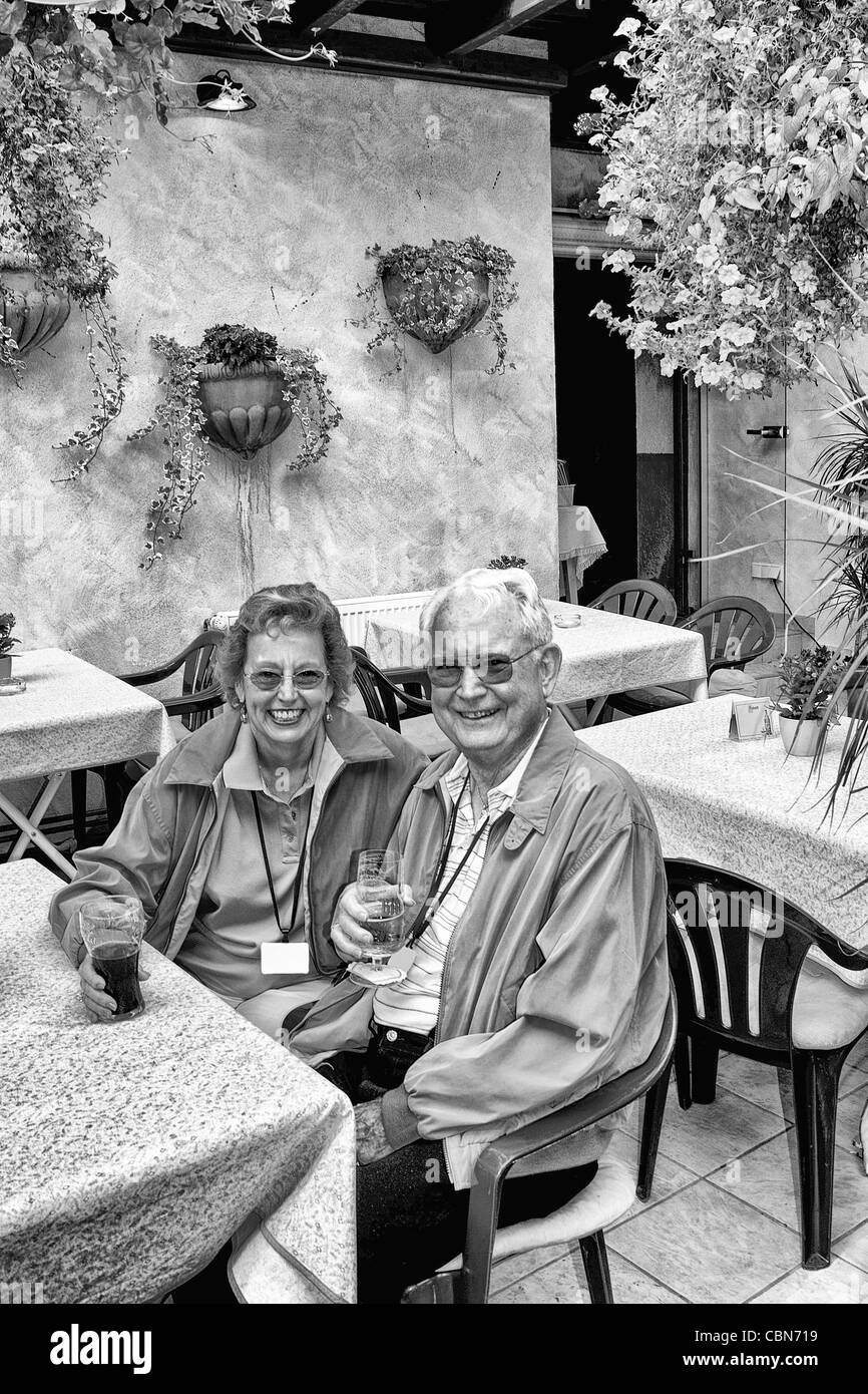 Retired couple vacationing in Germany at German Restaurant having wine ...