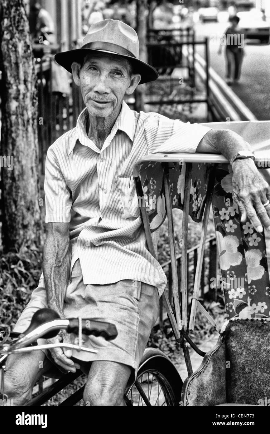 Rickshaw Driver in wealthy city and country of Singapore Stock Photo ...