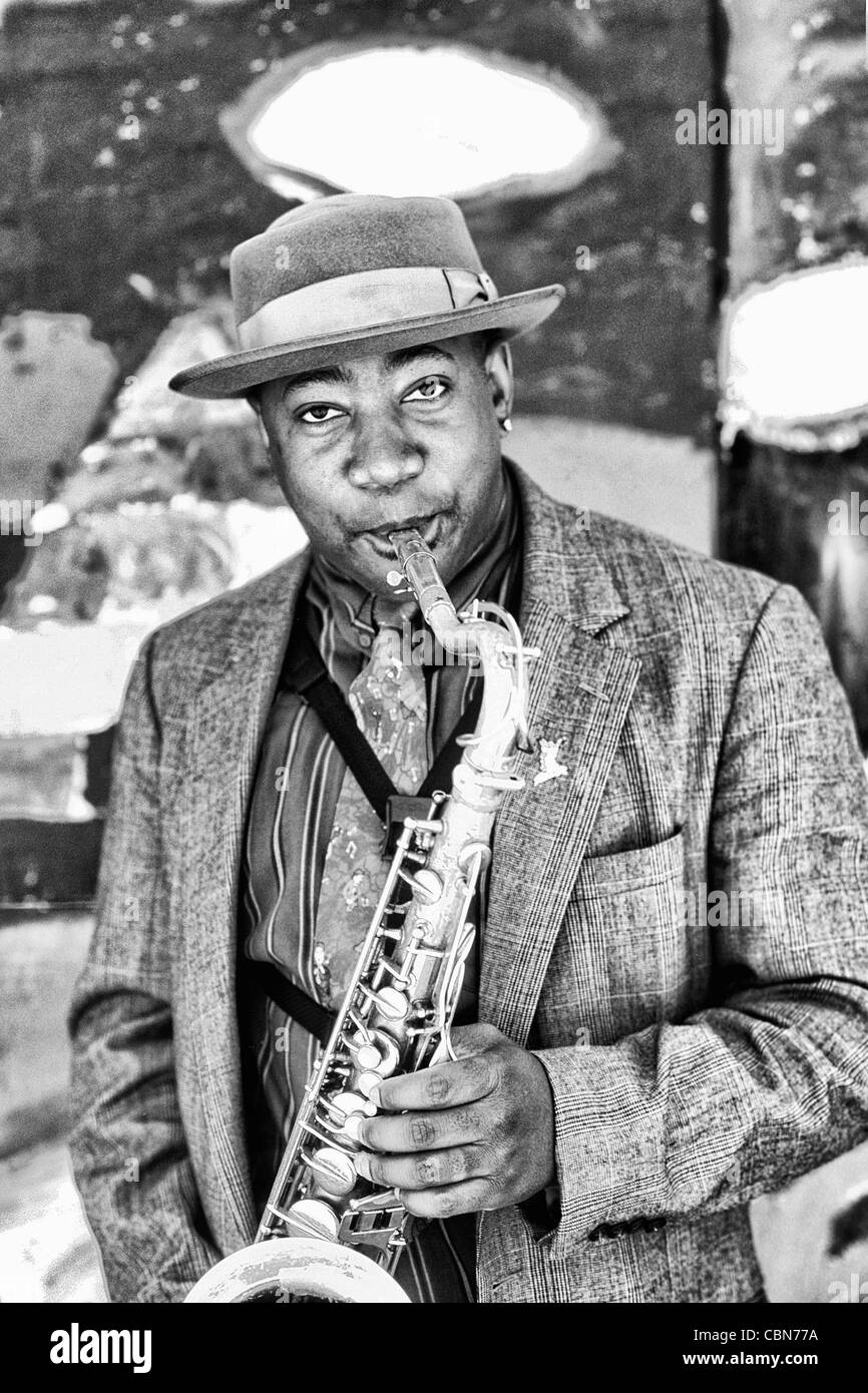 Black Afro American man playing jazz with saxophone or sax near ...
