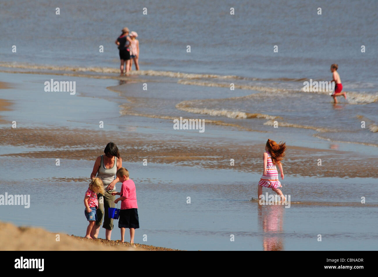 Children having fun on the beach at Skegness UK Stock Photo - Alamy