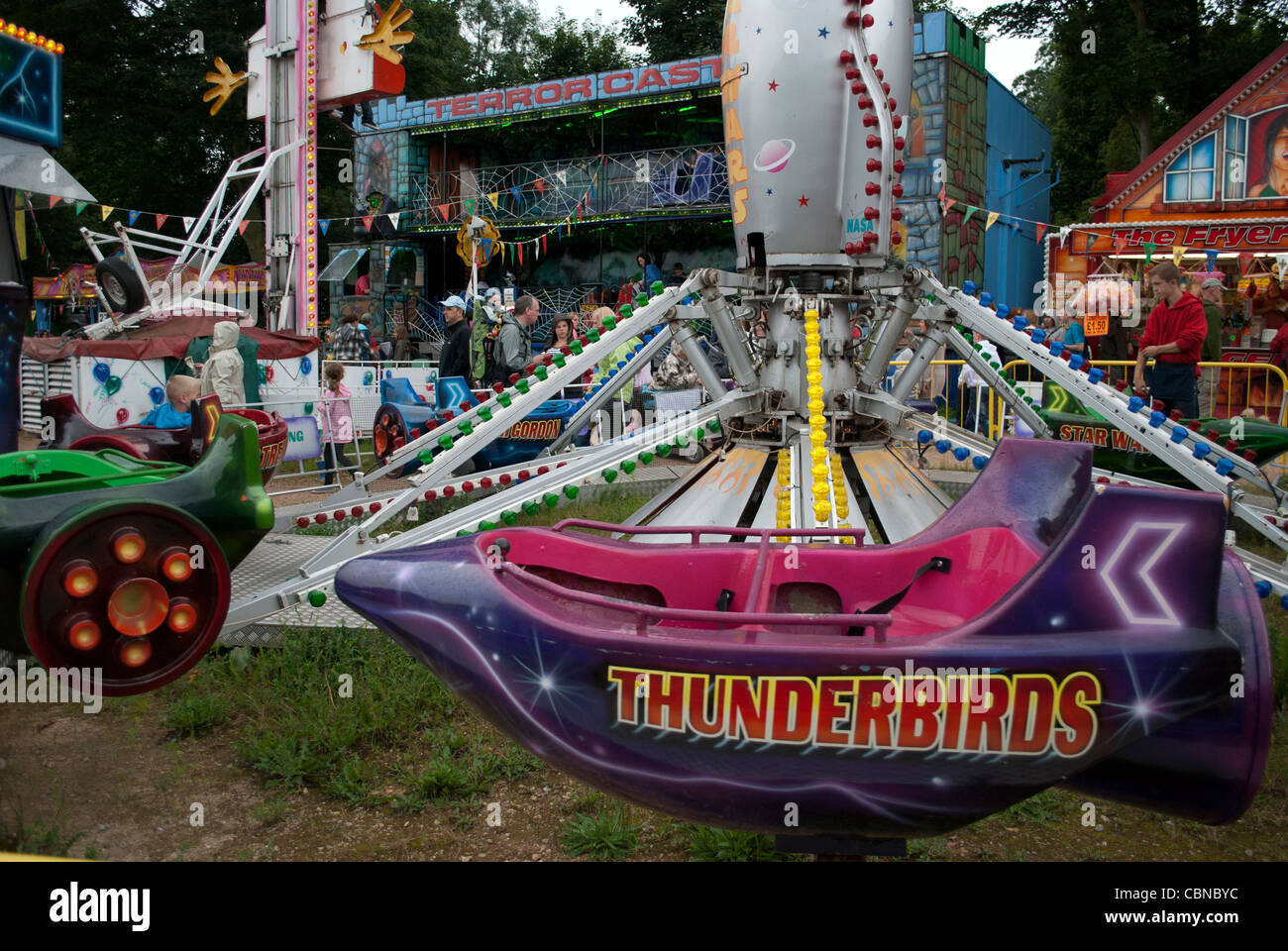 Fairground roundabout Star Wars rocket ride with purple Thunderbirds ...
