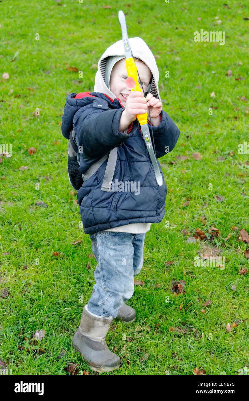A young boy with a bow and arrow Stock Photo - Alamy