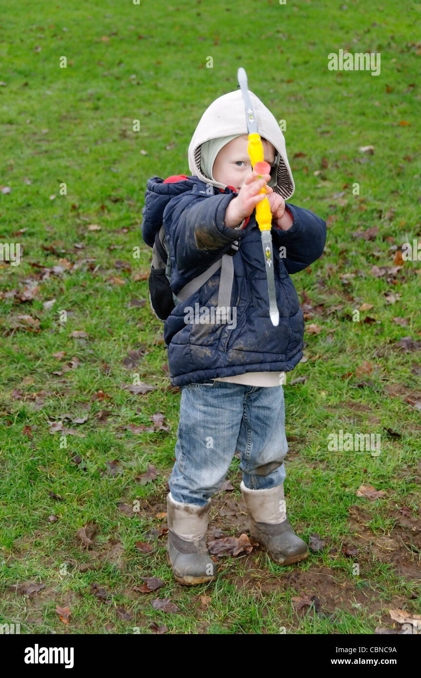 A young boy with a bow and arrow Stock Photo - Alamy
