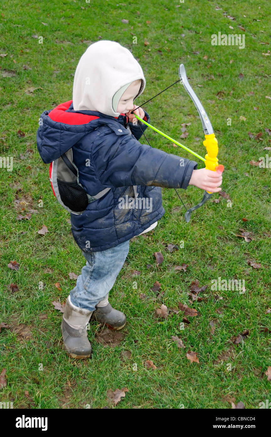 A young boy with a bow and arrow Stock Photo - Alamy