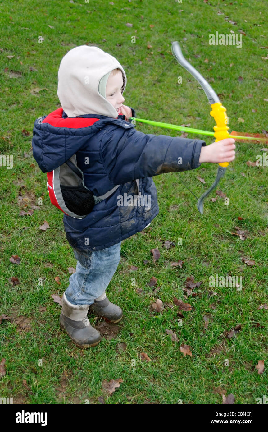 A young boy with a bow and arrow Stock Photo - Alamy