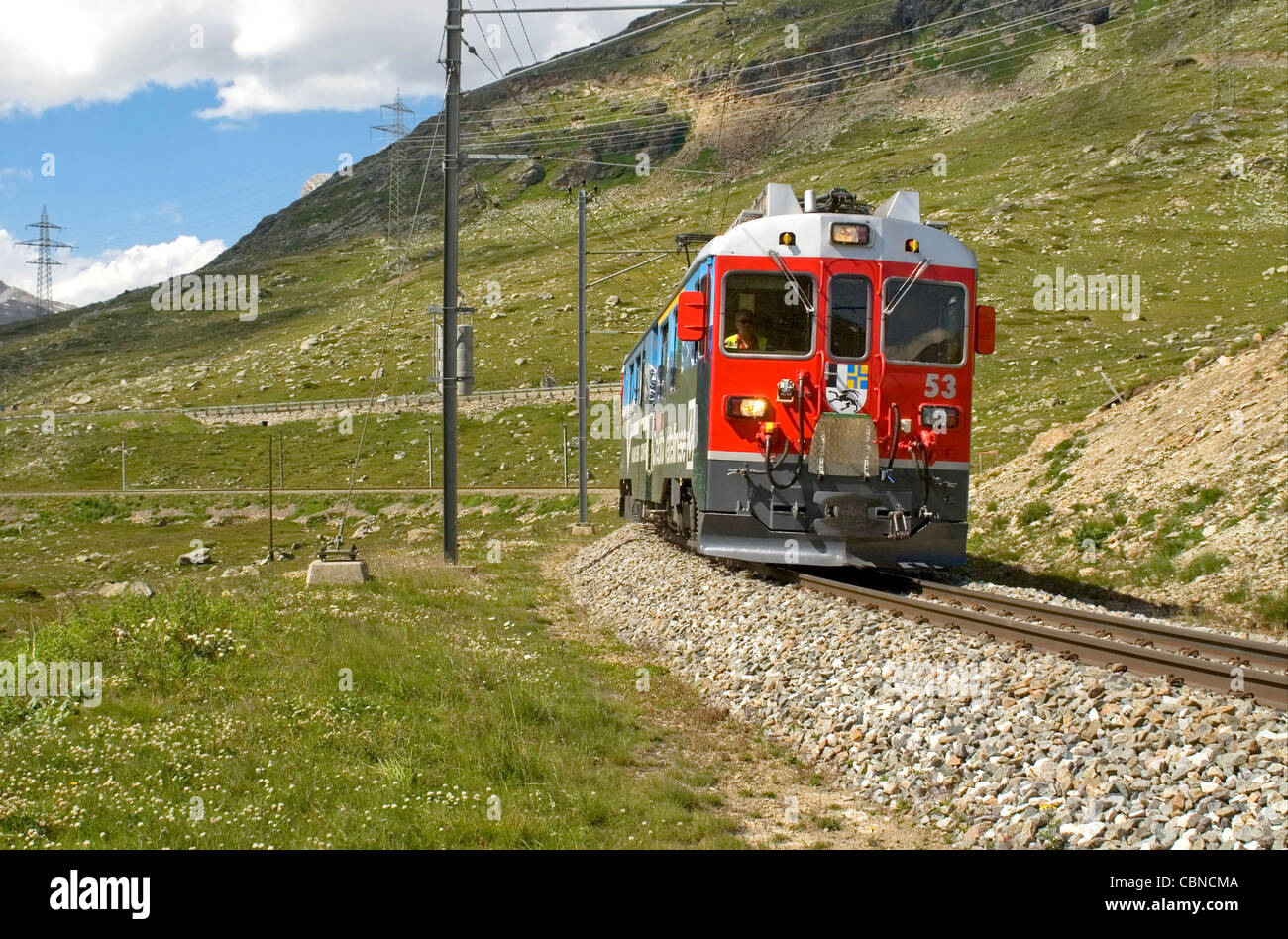 Alpine train in a mountain landscape at Lago Bianco, Bernina Pass ...