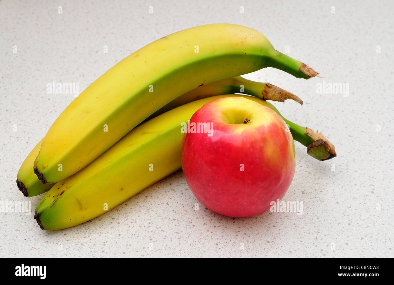 Bananas and apple Stock Photo - Alamy