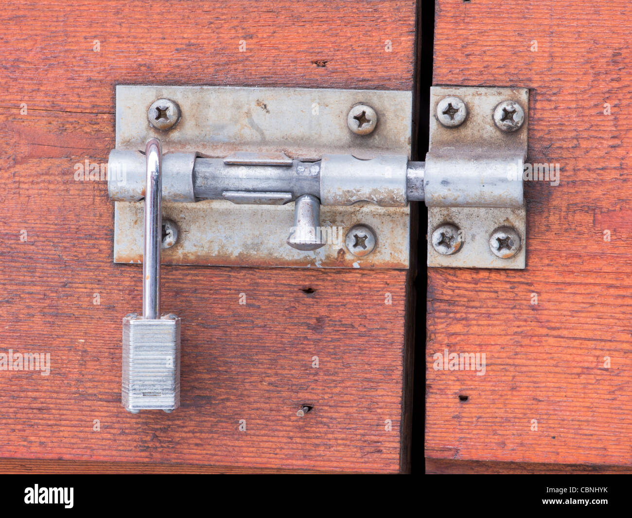 Metal lock on wooden doors Stock Photo - Alamy