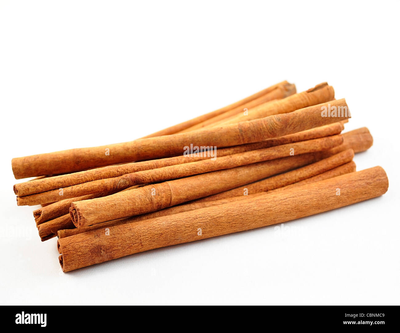a stack of cinnamon sticks on white background Stock Photo - Alamy