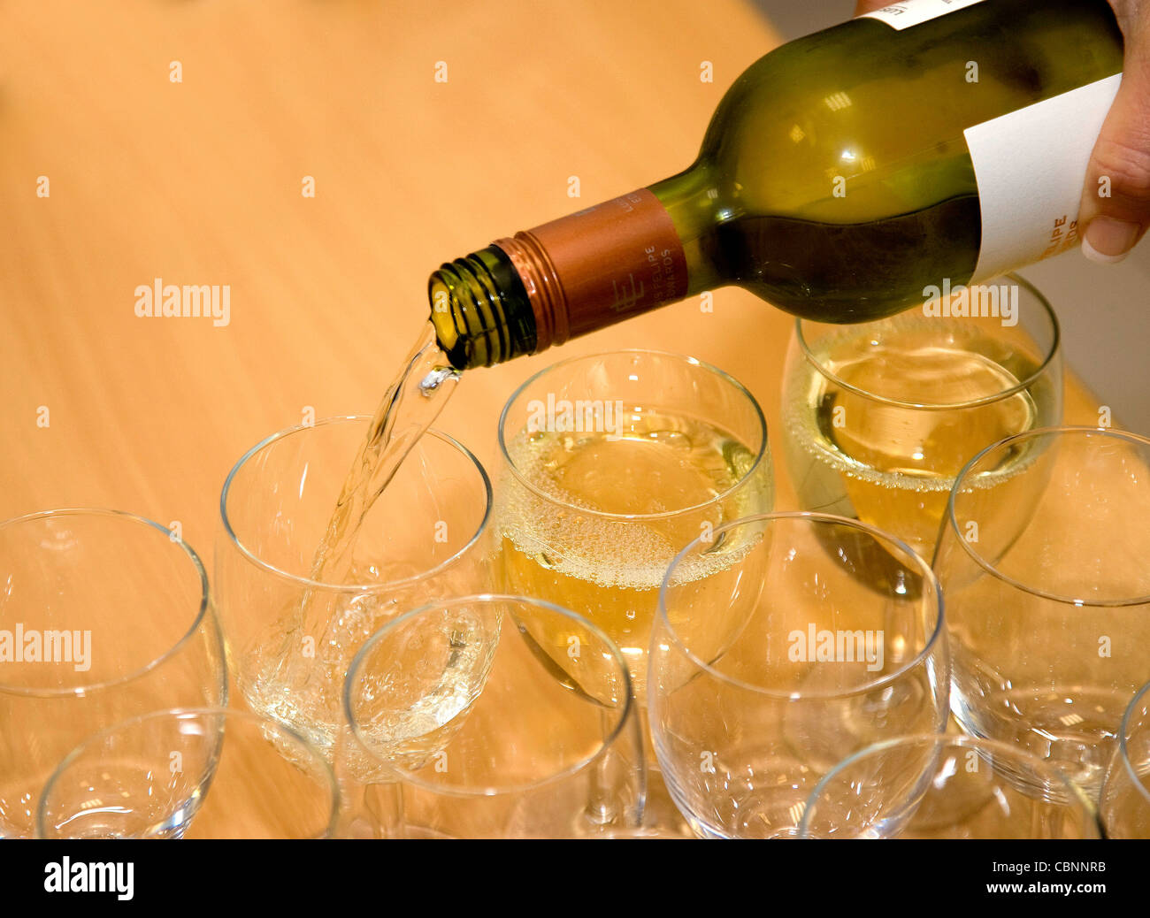 Pouring wine at a party Stock Photo - Alamy