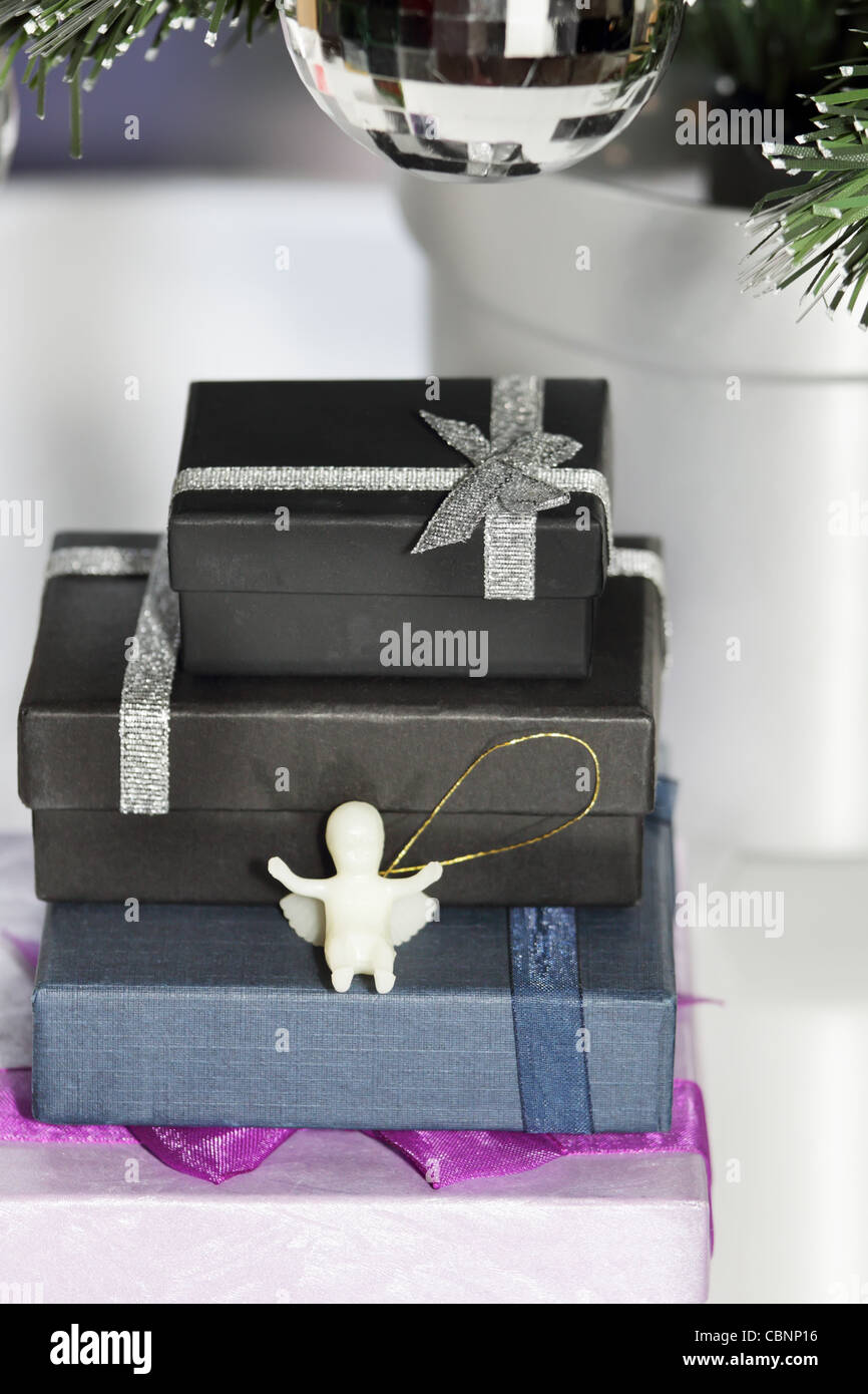 Presents under the Christmas Tree with Baby Angel Stock Photo - Alamy