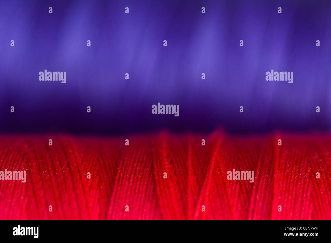 Red and purple reels of cotton Stock Photo - Alamy