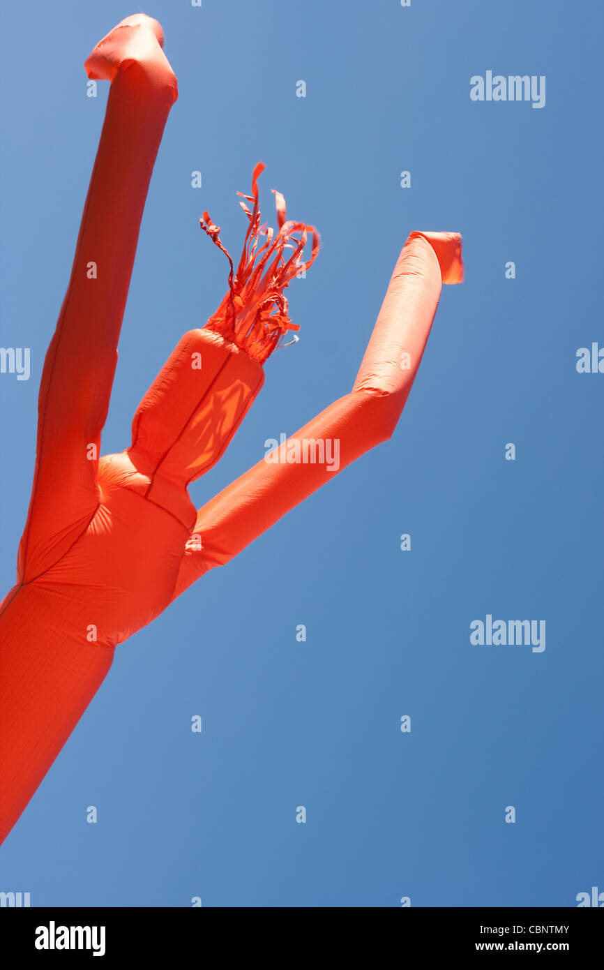 Blown up high by a windmachine a fabrique puppet is dancing in the air ...