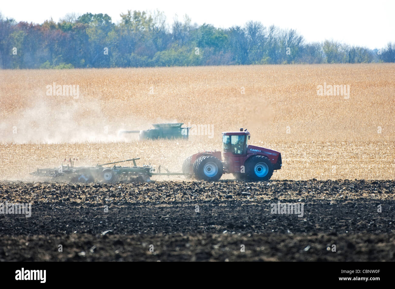A tractor plows a corn field after the crop has been harvested Stock ...