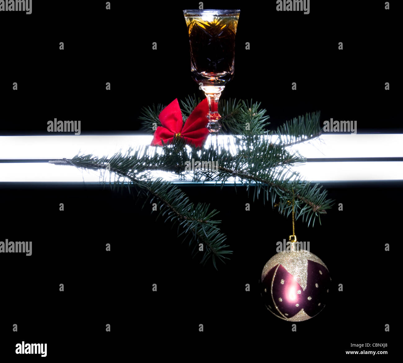 photo of still life with goblet of alcohol, tree branch and toy ...