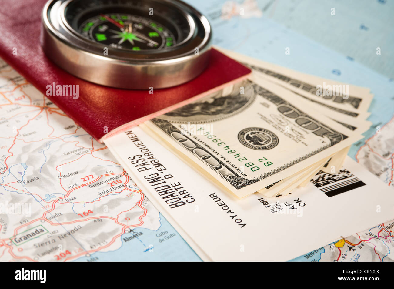 compass, money and passport with boarding pass Stock Photo - Alamy