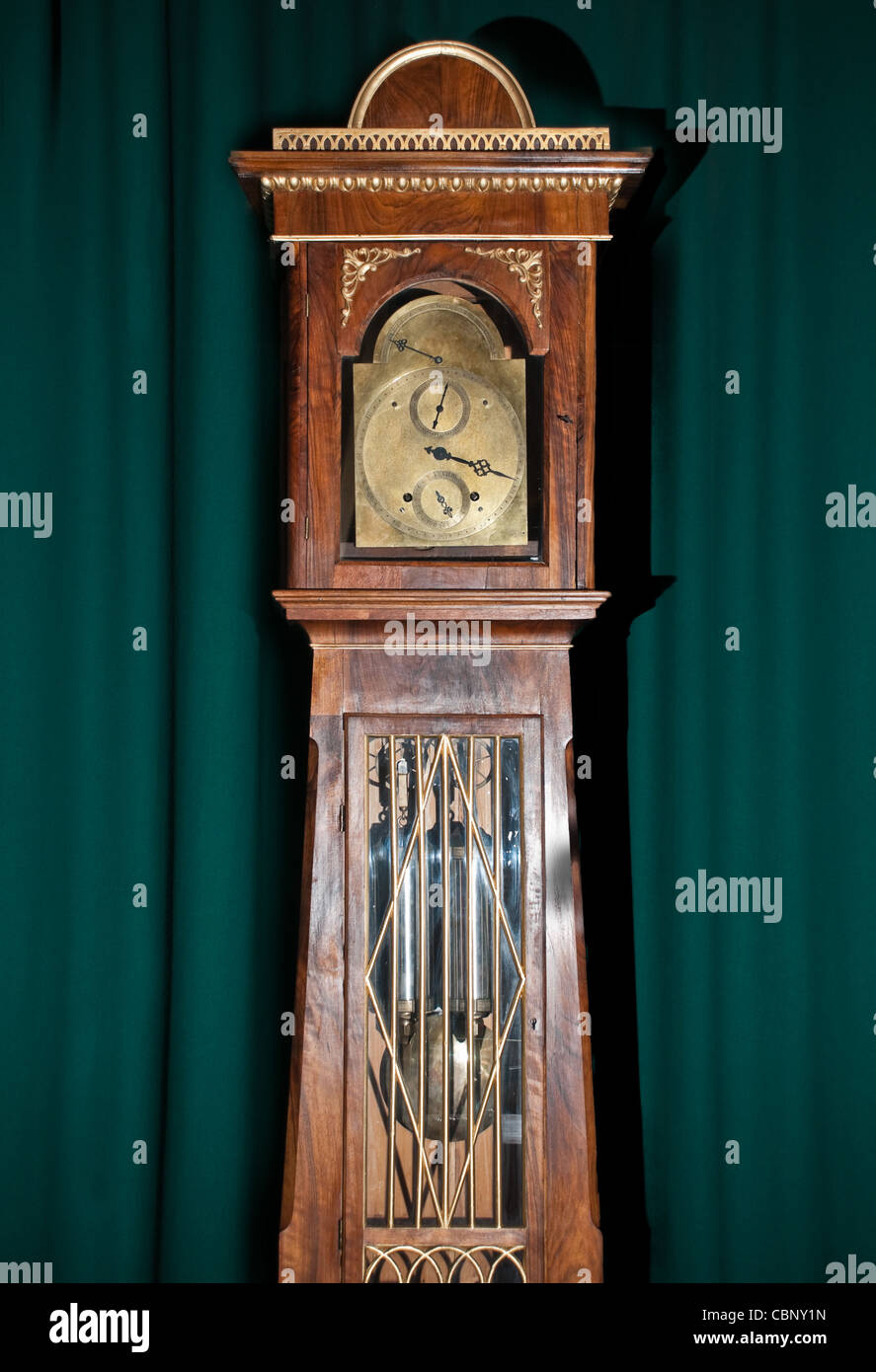 old tower clock made of wood with green curtain in background Stock ...