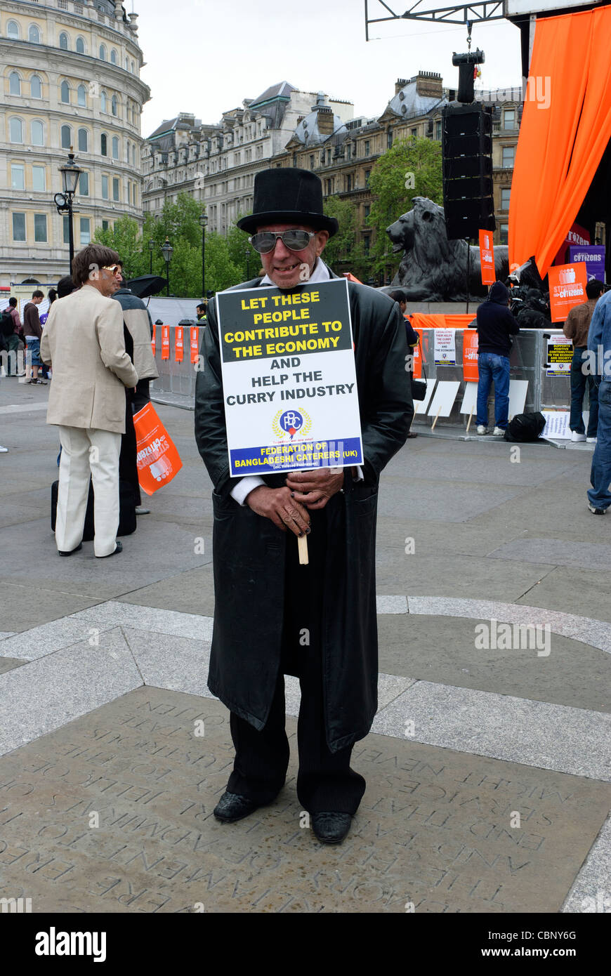 Man with a beaver hat holding a banner - March of the Strangers into ...