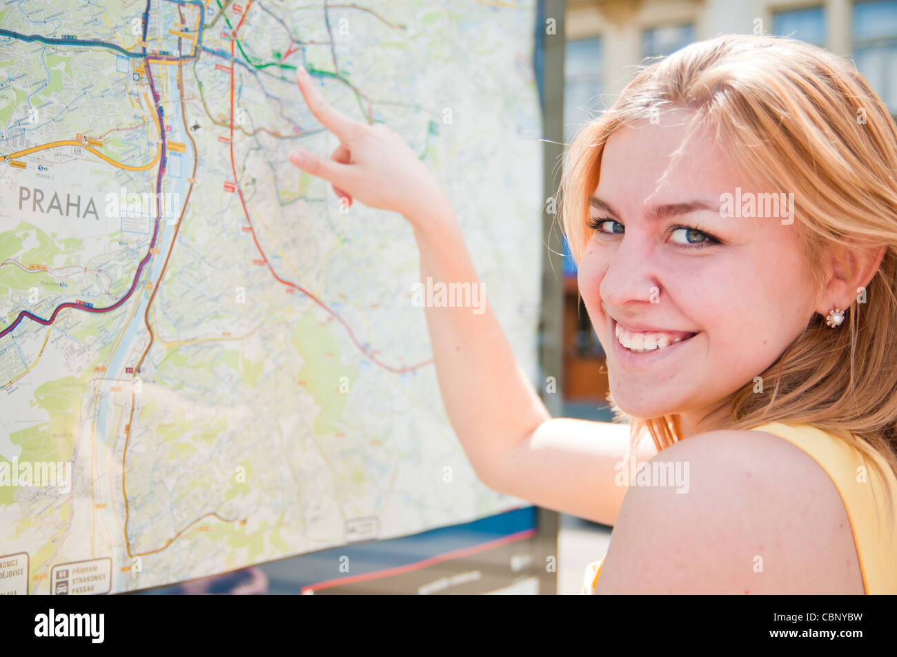 Young woman is looking on a map Stock Photo - Alamy