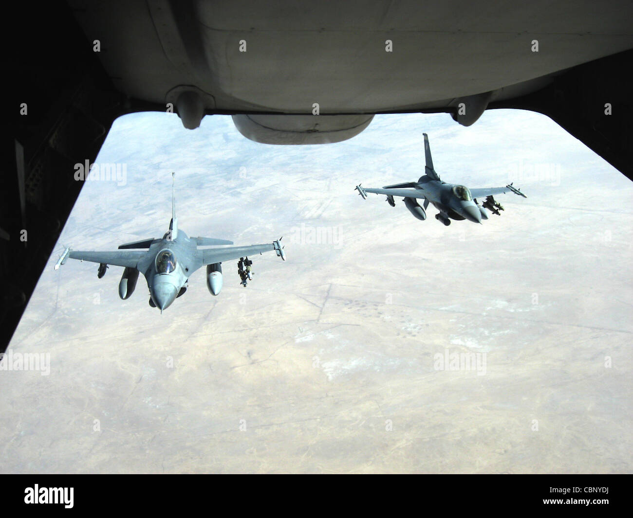 Two F-16 Fighting Falcons from Balad Air Base, Iraq, pull behind a KC ...