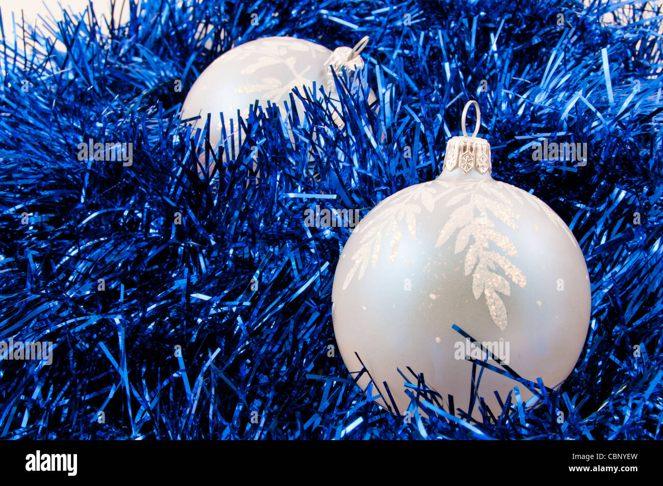 Christmas-tree decorations and blue tinsel Stock Photo - Alamy