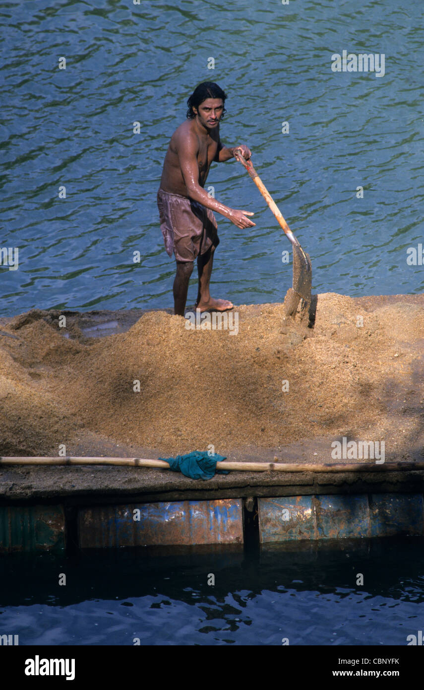 River sand miner (diver) working on barge, Kandy, Sri Lanka Stock Photo ...