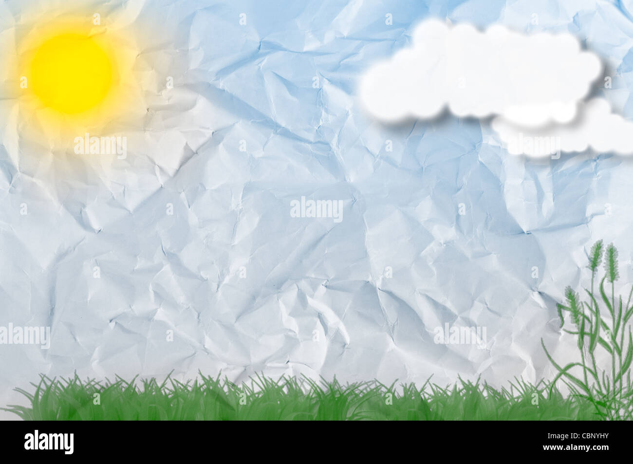 landscape with sun, cloud and grass on crumpled sheet of office paper ...