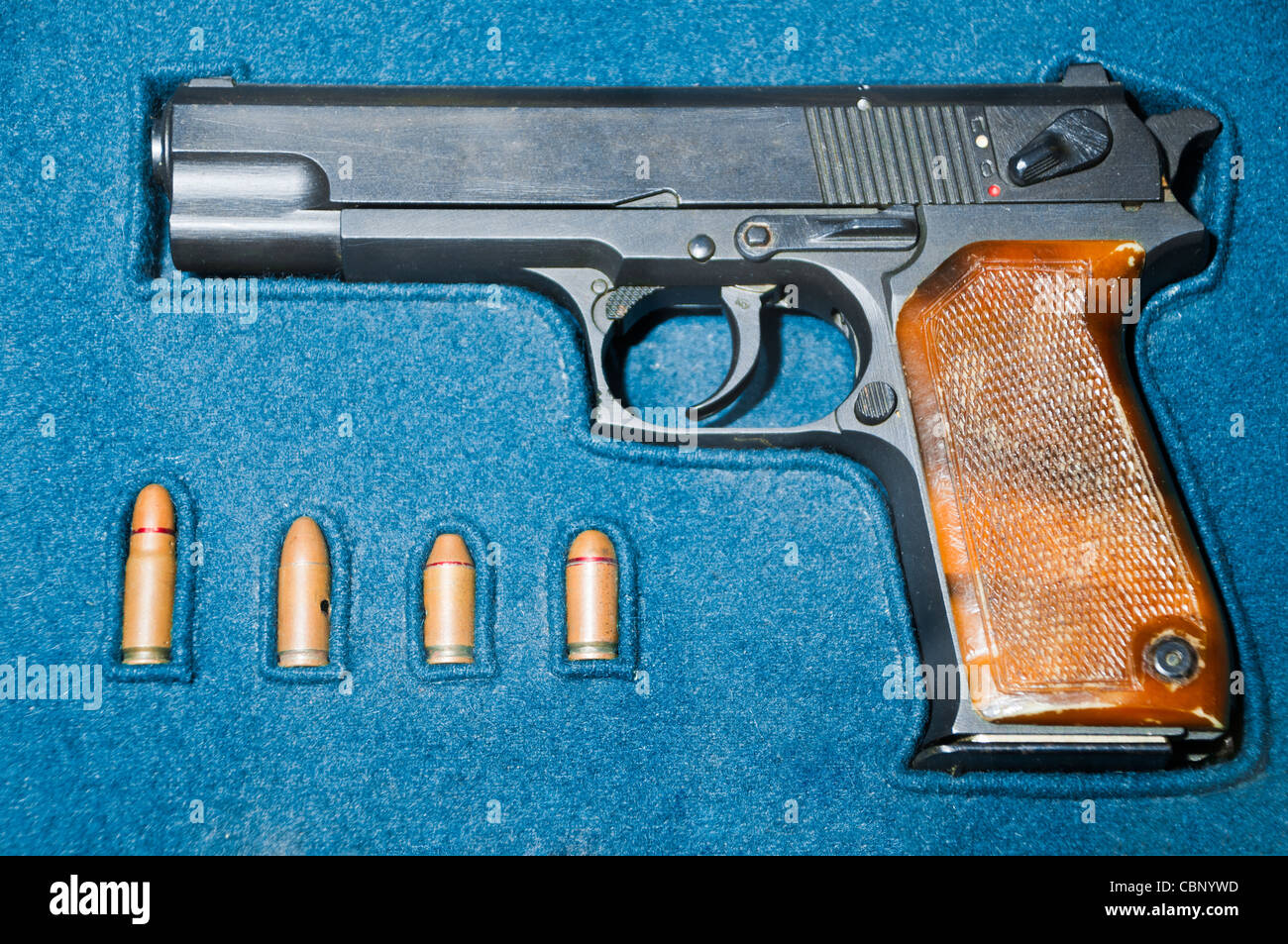 pistol and four bullets in blue box Stock Photo - Alamy