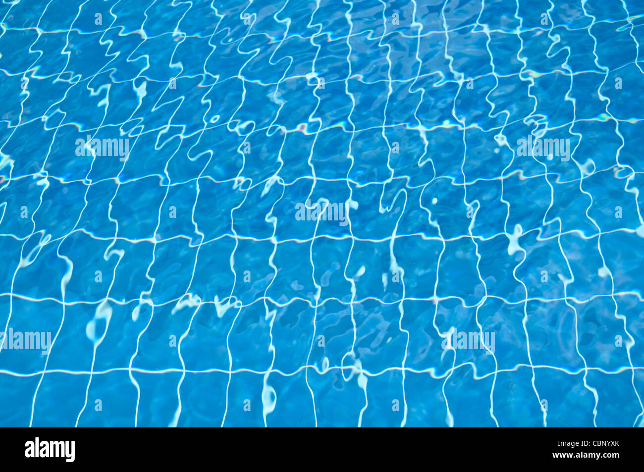 pool bottom visible through clear blue and transparent water with ...